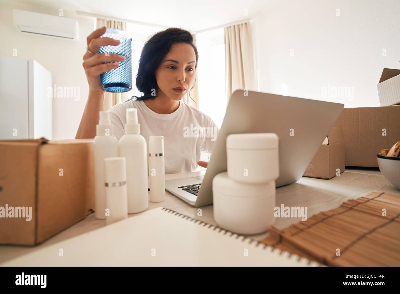 Concentrated Internet store employee processing customer order Stock ...