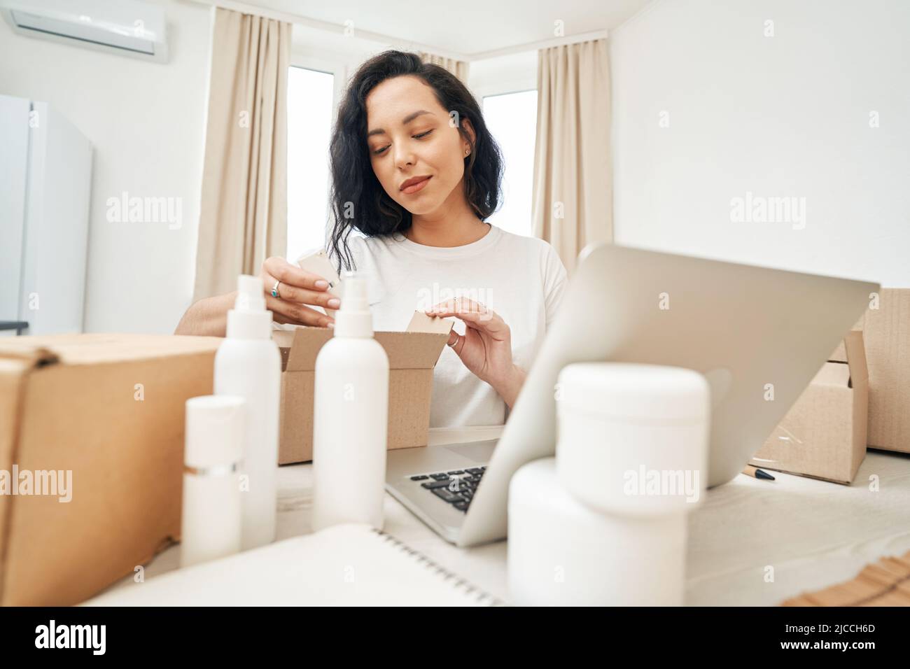 Online store employee packing wares for shipping Stock Photo - Alamy
