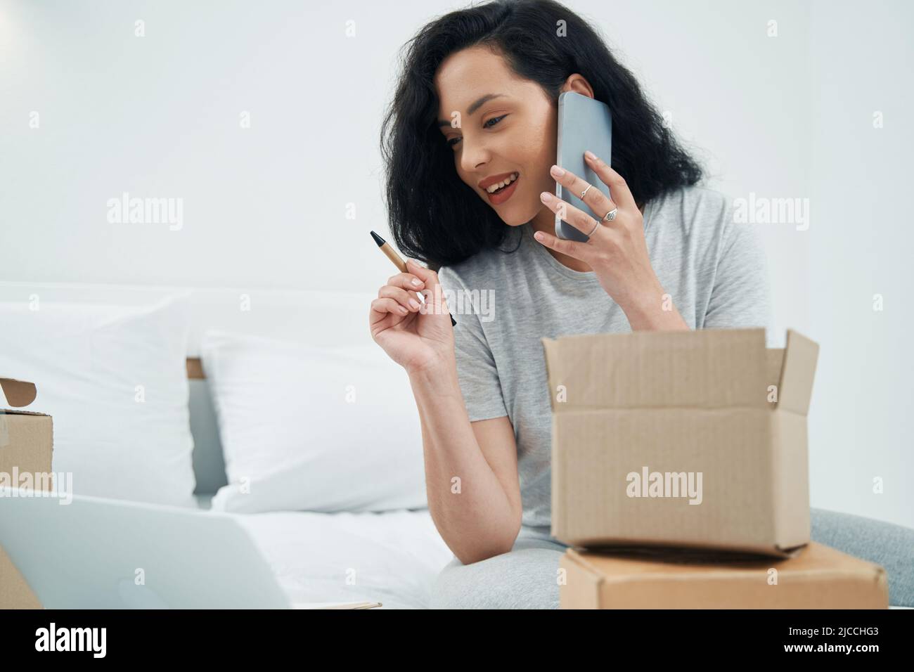Online store owner talking to customer on smartphone Stock Photo - Alamy