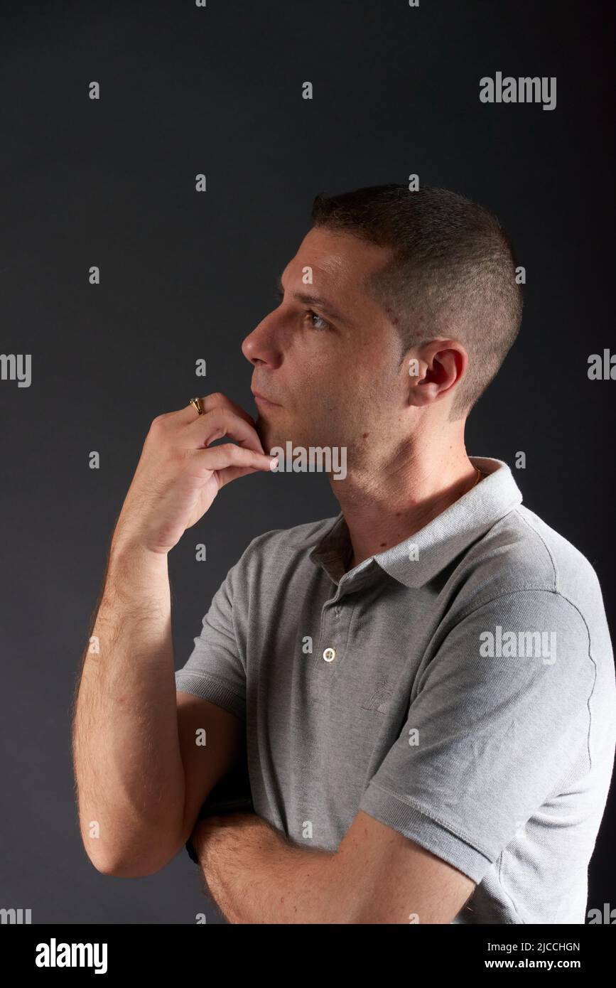A young male model in a pensive attitude posing in a studio Stock Photo ...