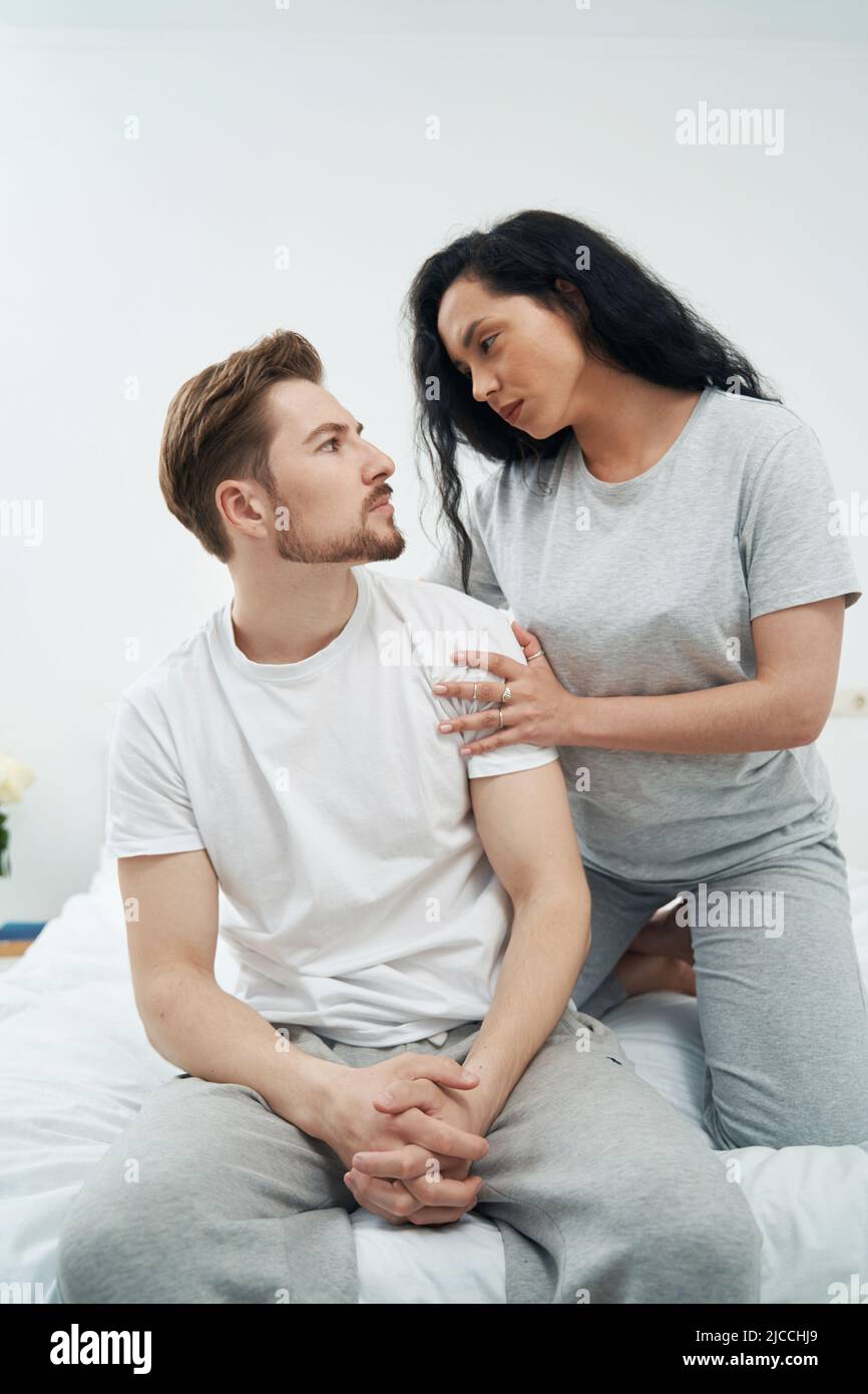 Woman consoling man bed hi-res stock photography and images - Alamy