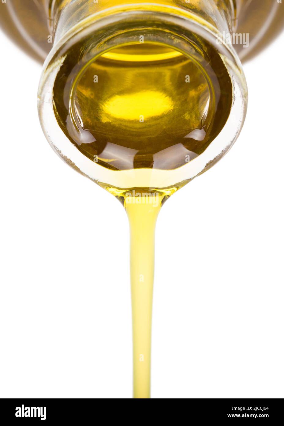 Oil pouring from a bottle. Isolated on white Stock Photo - Alamy