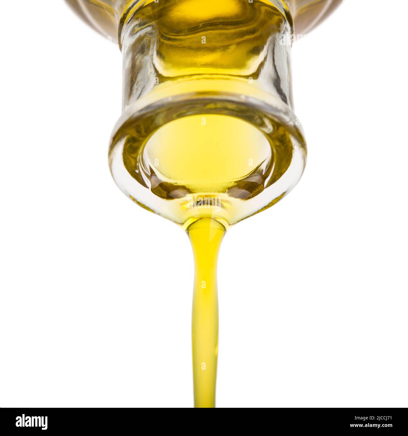 Oil pouring from a bottle. Isolated on white Stock Photo - Alamy