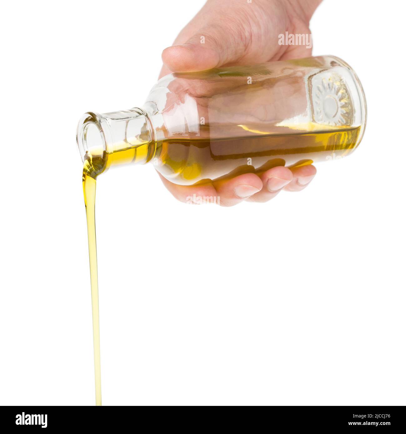 Male hand holding a bottle. Oil pouring from a bottle Stock Photo - Alamy