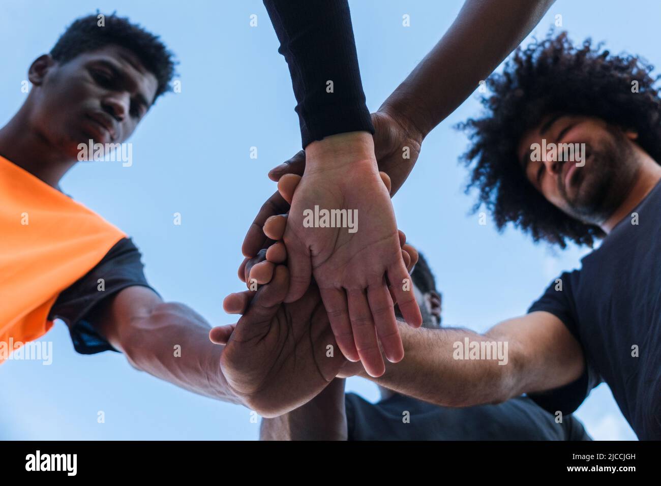 Group of friends putting hands together as a team - focus on hands ...