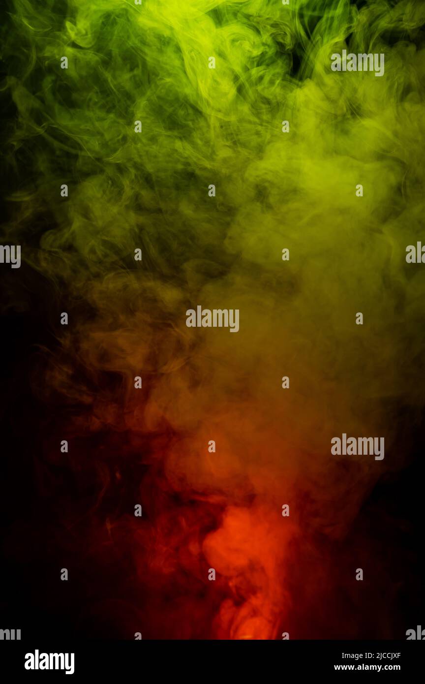 Red-yellow smoke spreads on a black background Stock Photo - Alamy