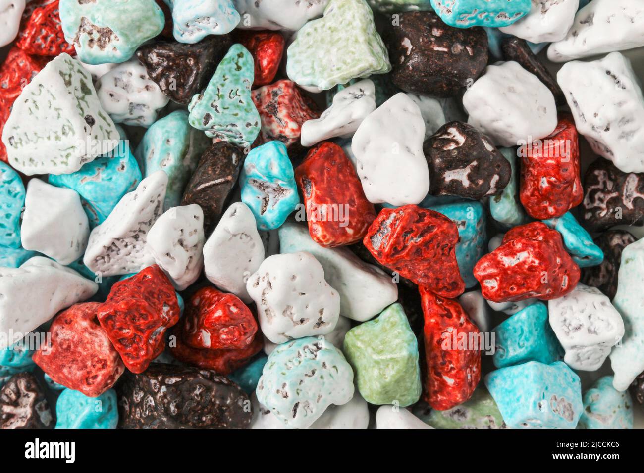 Dragee candies in the form of multi-colored pebbles as a background ...