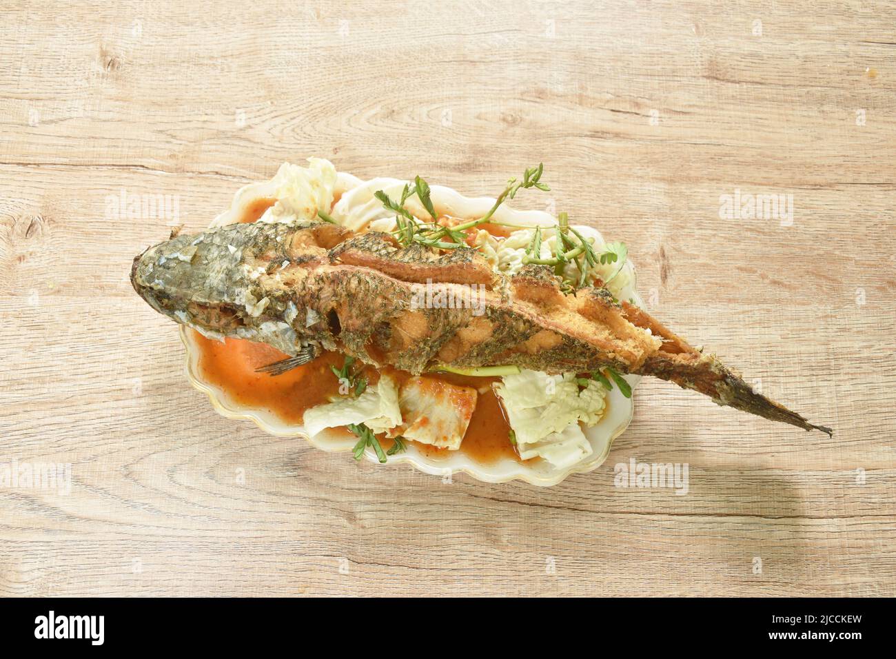 fried snake head fish and water mimosa with cabbage in spicy sour soup ...