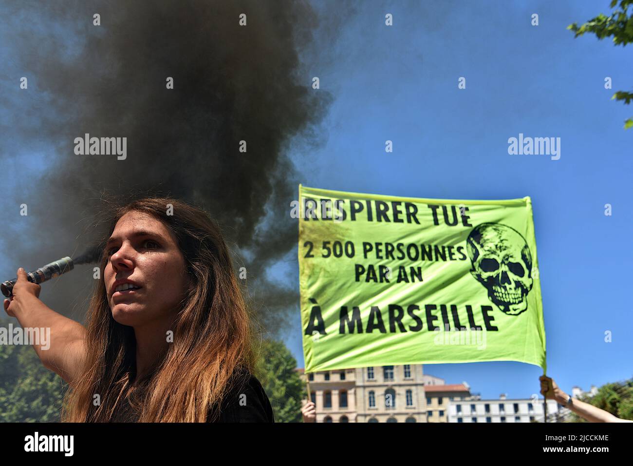 Marseille, France. 11th June, 2022. Protester holds a black smoke bomb ...