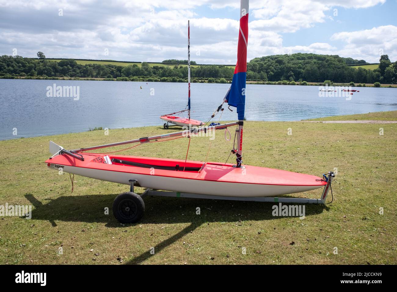 Topper class sailing dinghies on grass at the edge of a lake Stock ...