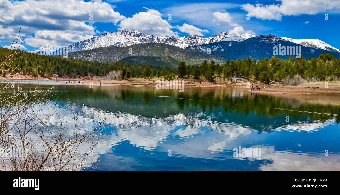 Pikes Peak panorama. Snow-capped and forested mountains near a mountain ...