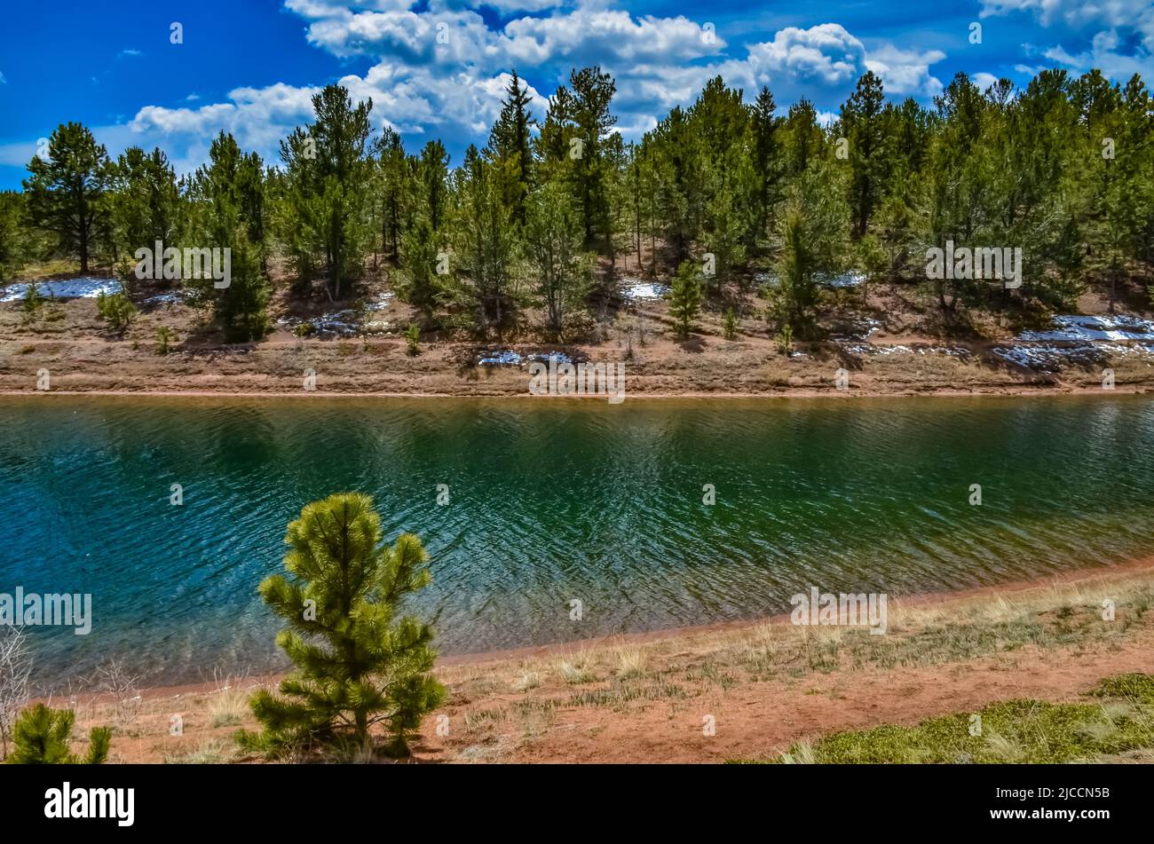 Crystal Creek reservoir near snow-capped mountains Pikes Peak Mountains ...