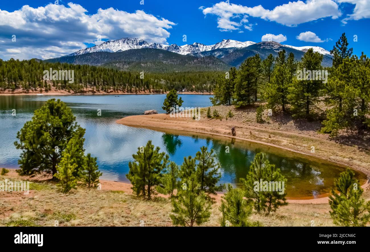 Pikes Peak panorama. Snow-capped and forested mountains near a mountain ...