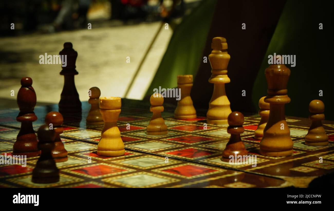Chess, chess board and wooden chess pieces in nature at the campsite ...
