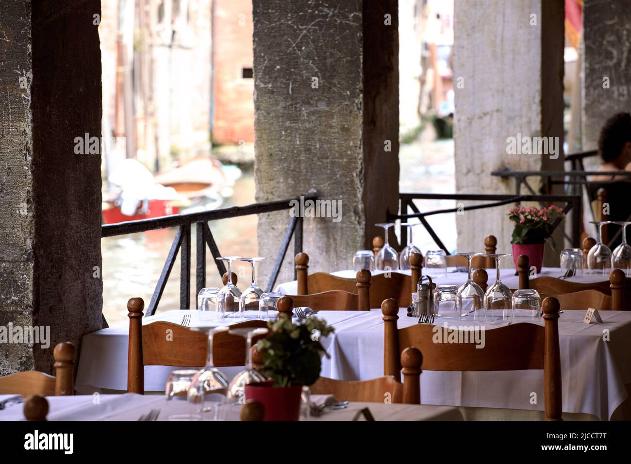 Romantic italian restaurant, elegant tables outdoors by the canal. Old ...