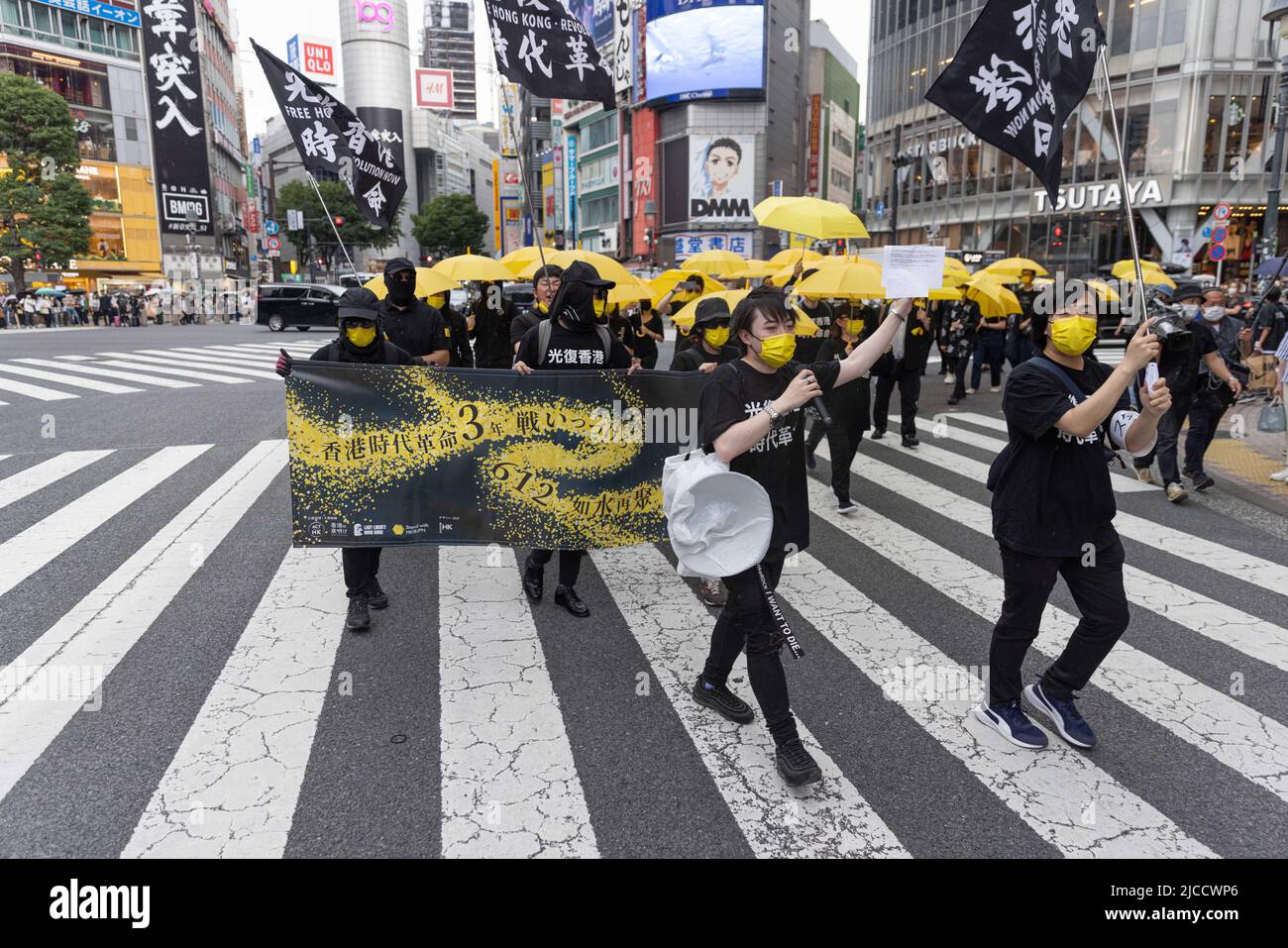 Demonstrators chant pro-democracy slogans while marching through the ...