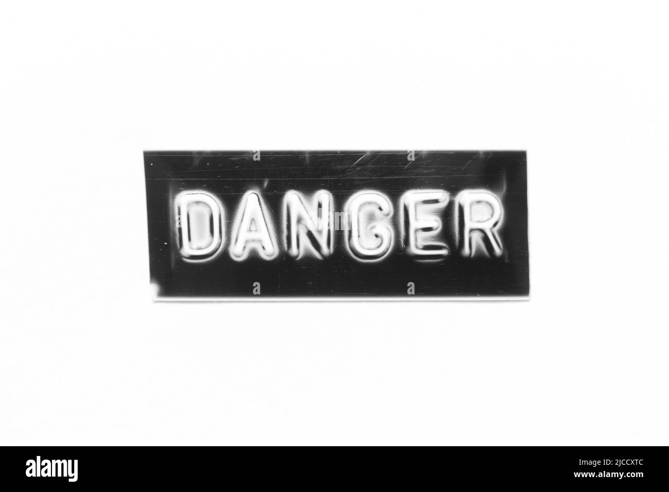 Black color banner that have embossed letter with word danger on white ...