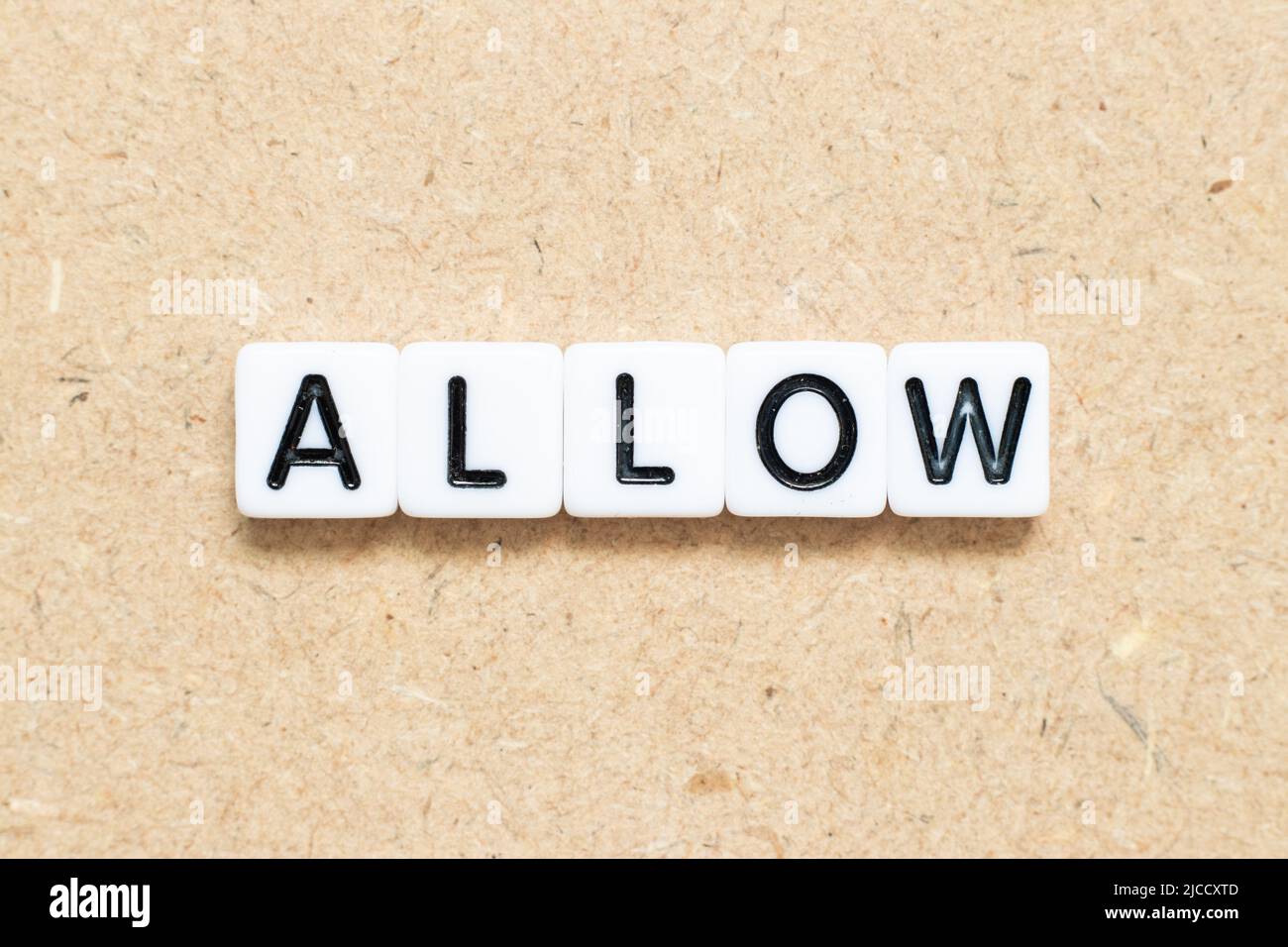 White tile alphabet letter with word allow on wood background Stock ...