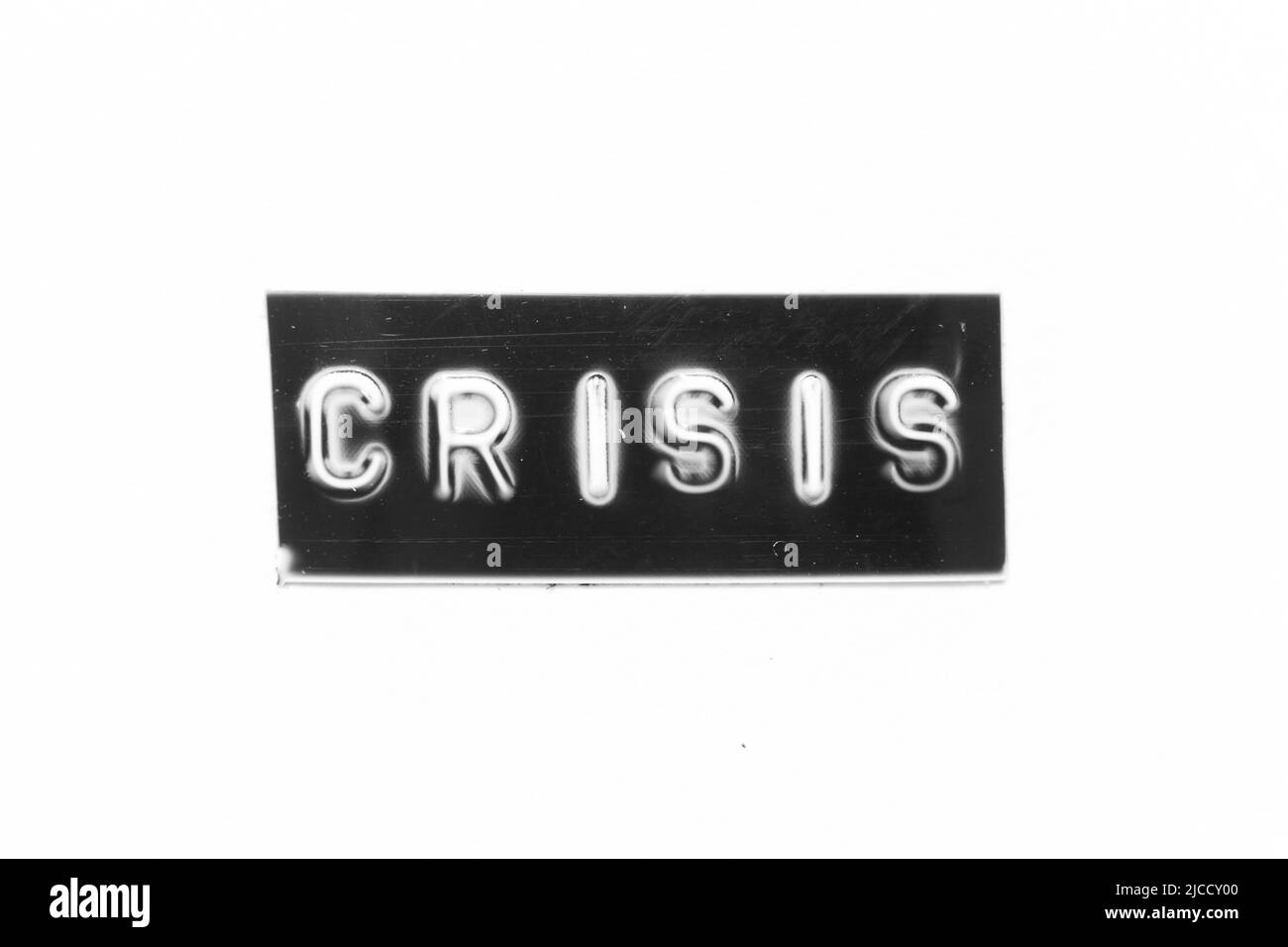 Black color banner that have embossed letter with word crisis on white ...