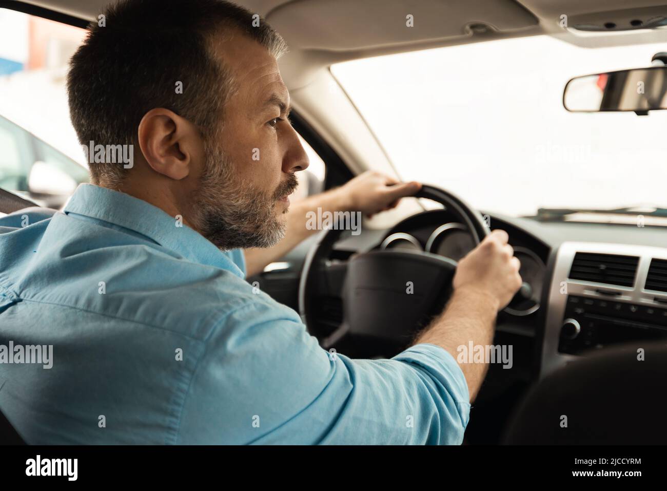 Male Driver Driving Sitting In Automobile, Back View Stock Photo - Alamy