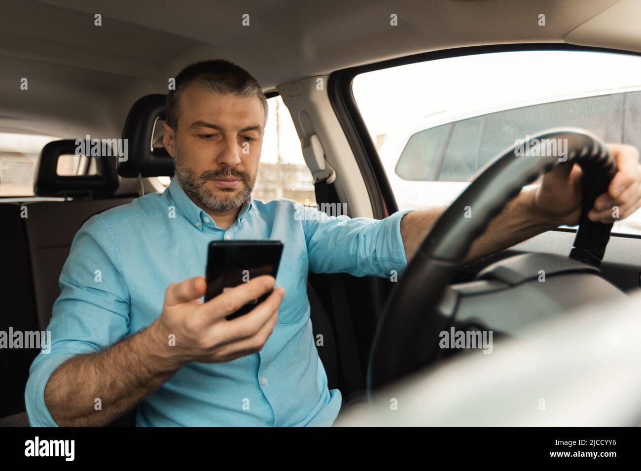 Male Driver Using Smartphone For Navigation Driving New Car Stock Photo ...