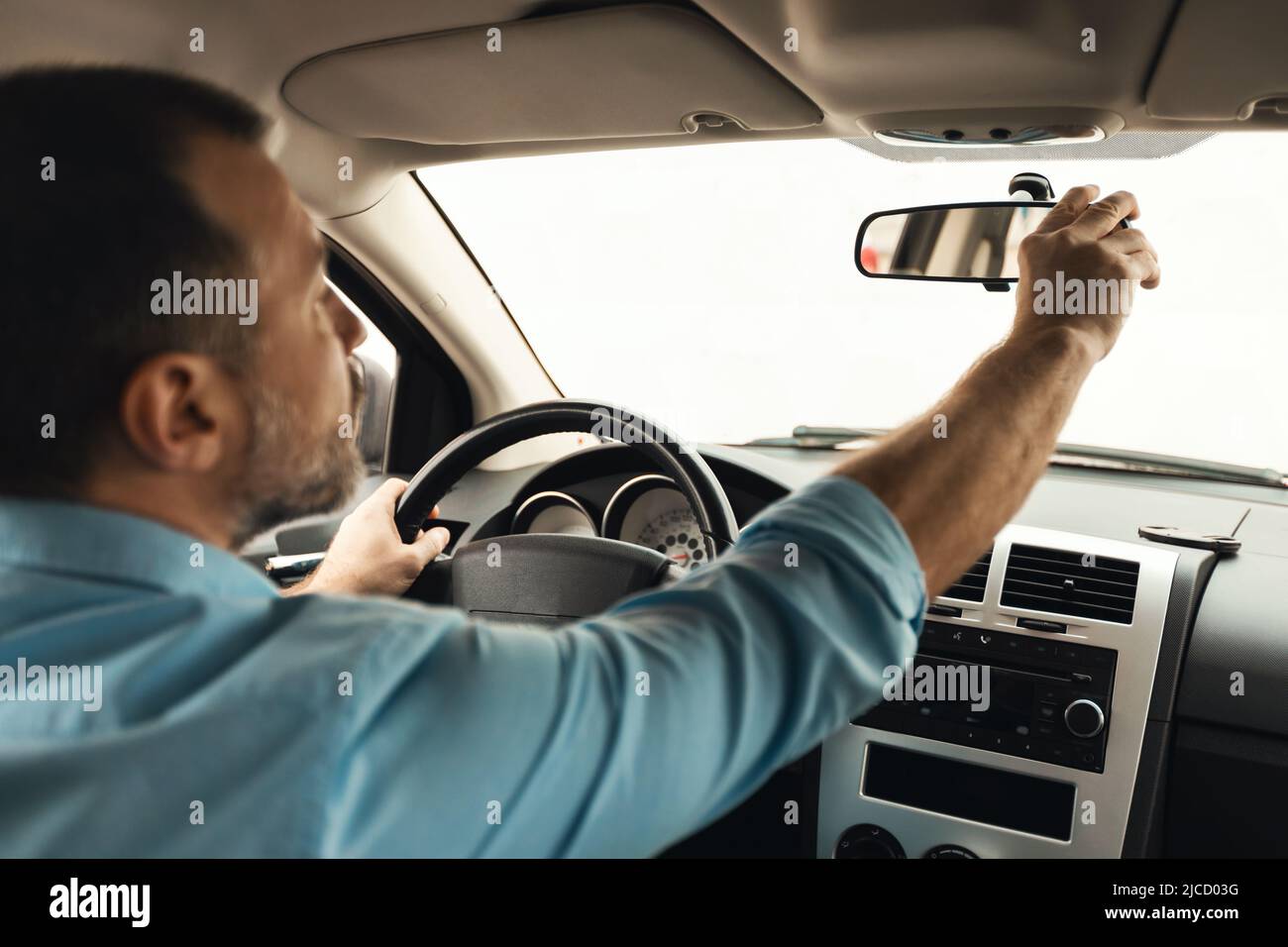 Driver Man Adjusting Rear View Mirror Sitting In New Automobile Stock ...