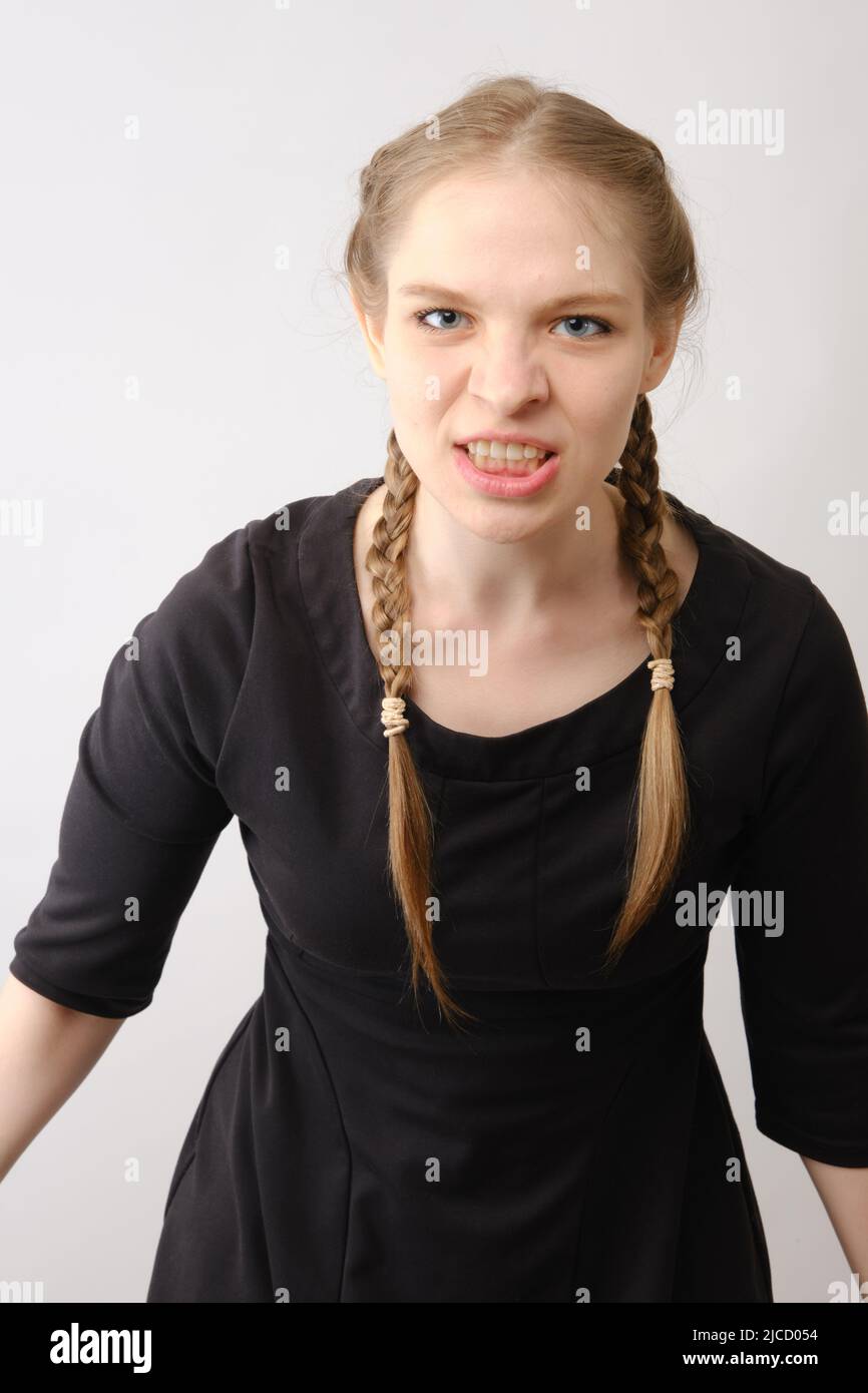 The young emotional angry woman screaming on white studio background ...