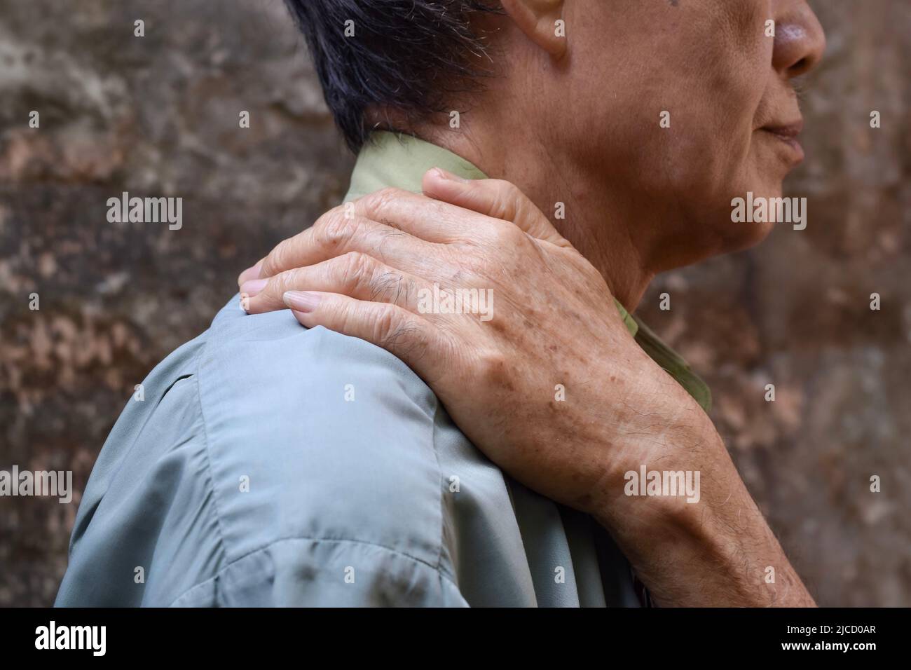 Pain in the shoulder muscle of Southeast Asian elder man. Concept of ...