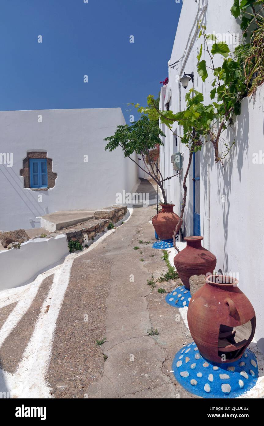 Attractive whitewashed street scene with colourful flower pots. Megalo ...