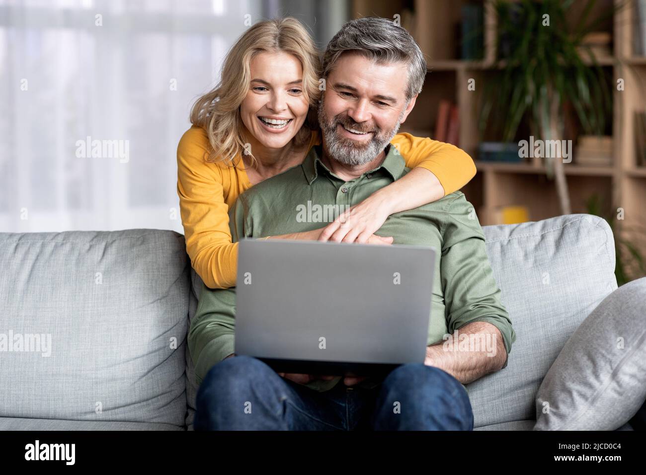 Mature couple relaxing home video hi-res stock photography and images ...