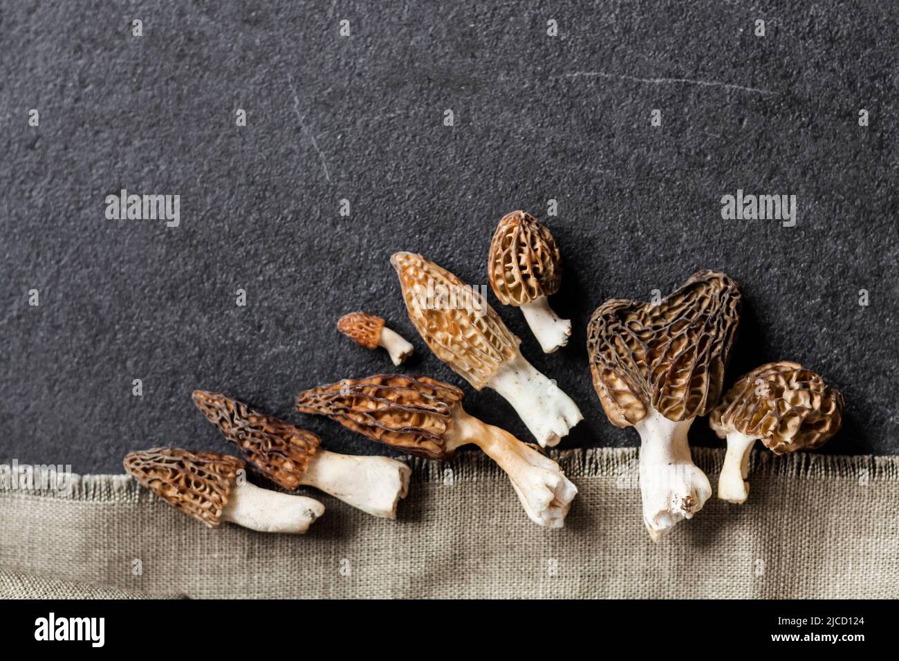Morel mushrooms closeup on black background. Flatlay Stock Photo - Alamy