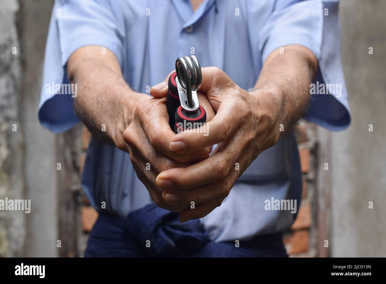 Southeast asian, Myanmar old man gripping hand exercise gripper Stock ...
