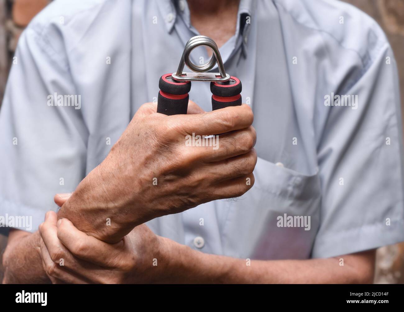 Southeast asian, Myanmar old man gripping hand exercise gripper Stock ...