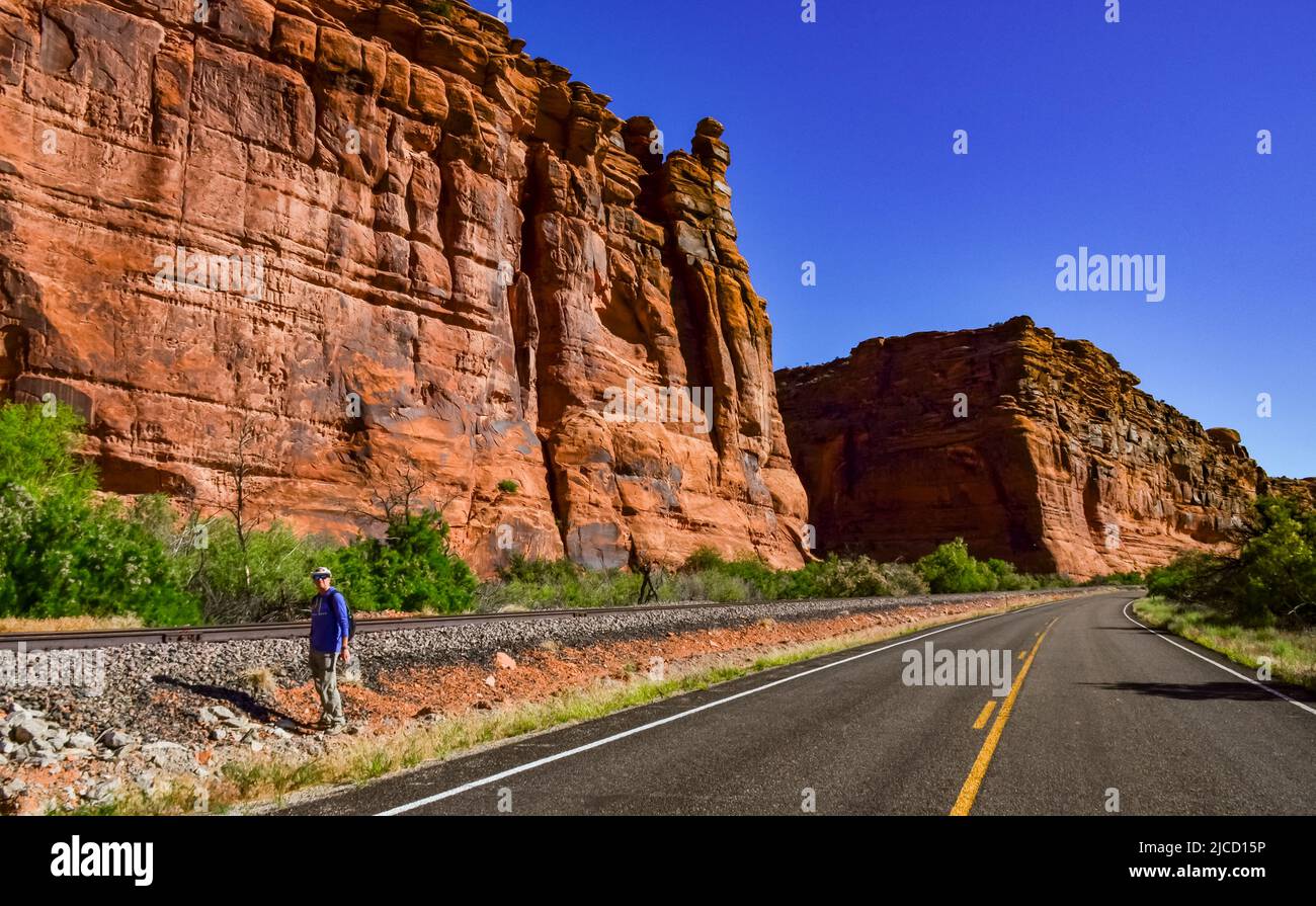 Asphalt road near Layered geological formations of red rocks in ...