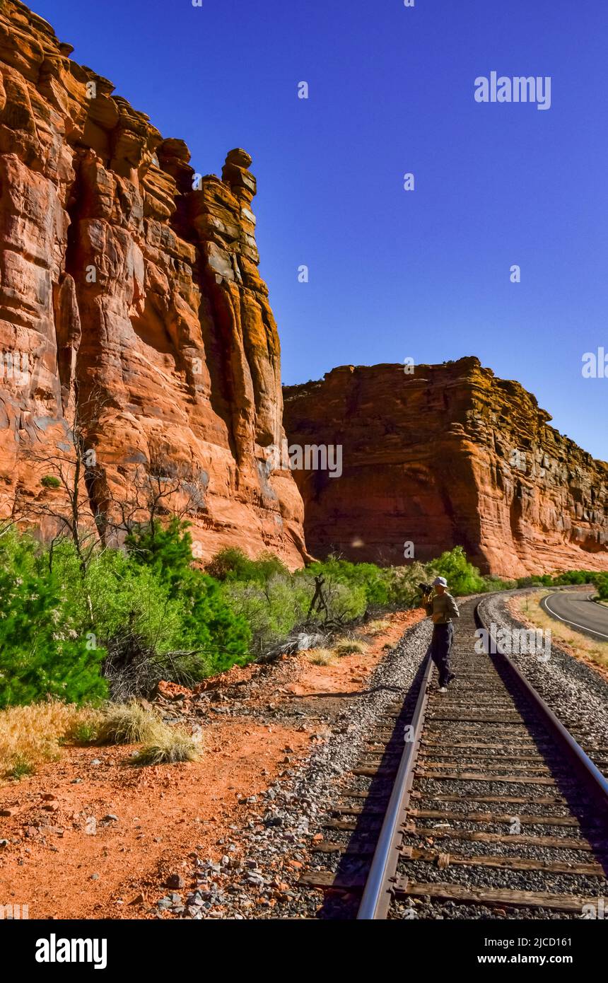 Railroad at the bottom of a canyon next to Layered Geological ...