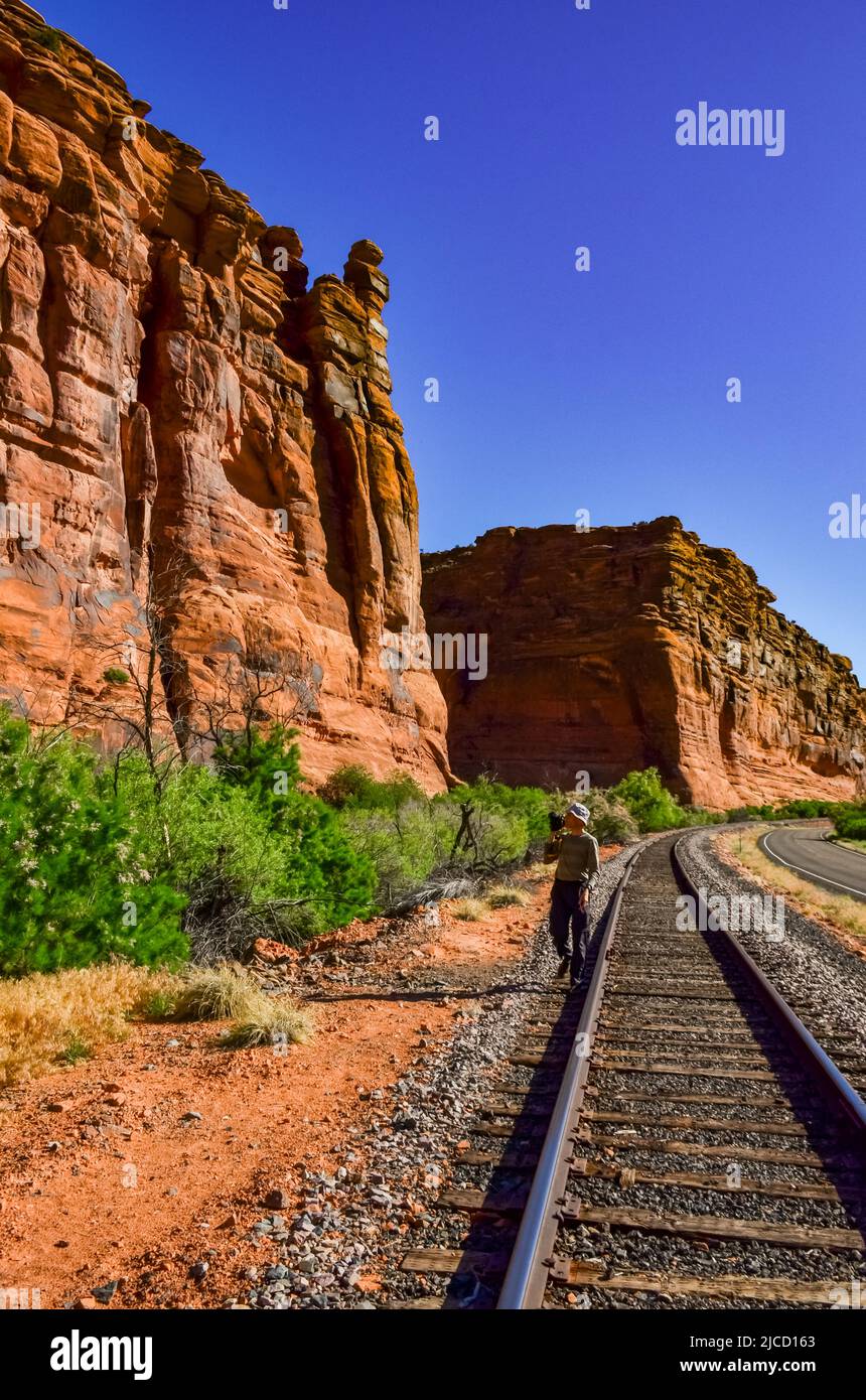 Railroad at the bottom of a canyon next to Layered Geological ...