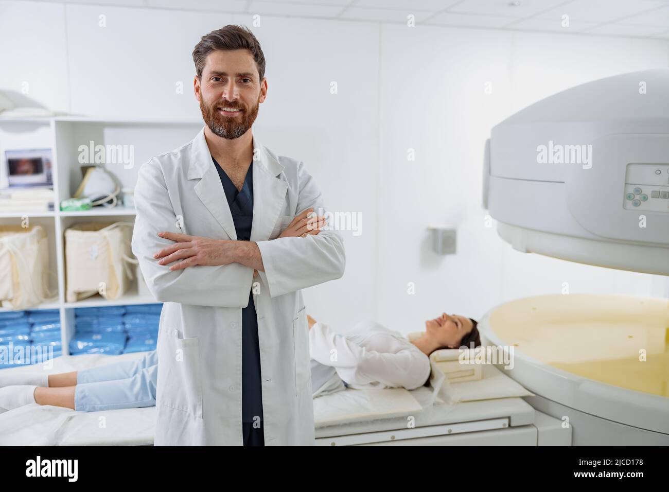 Radiologist on background of MRI or CT or PET Scan with female patient ...