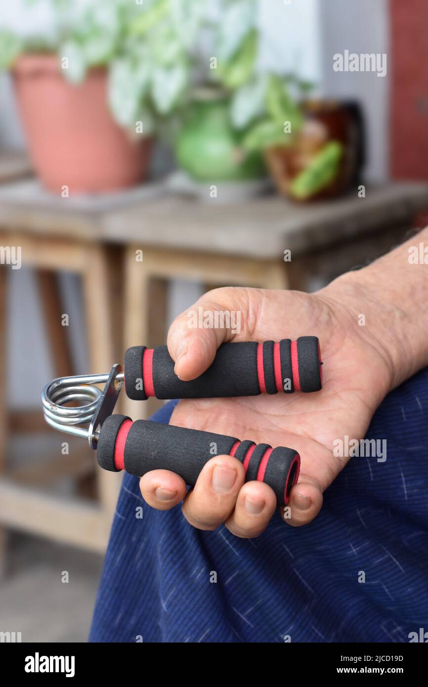 Southeast asian, Myanmar old man gripping hand exercise gripper Stock ...