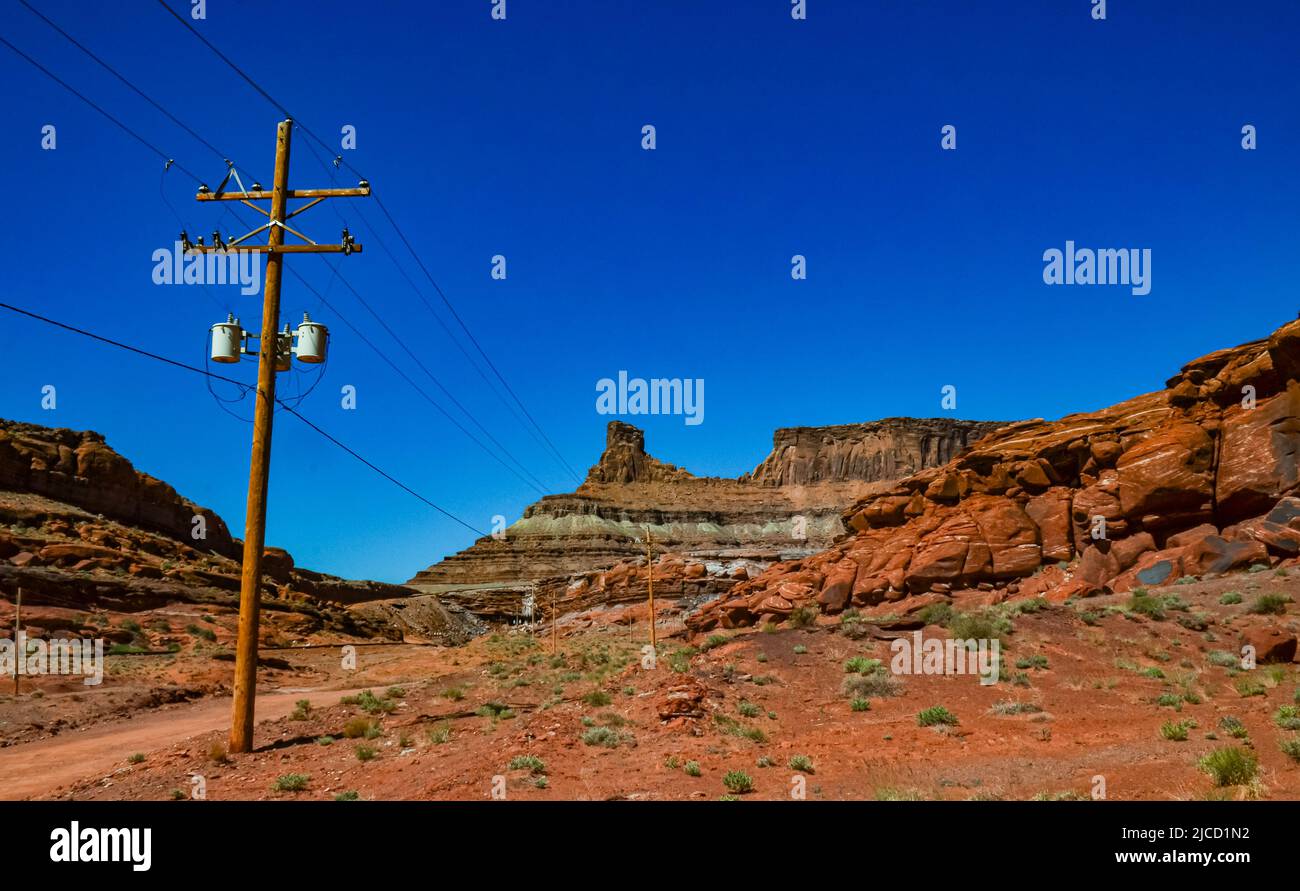 Wooden pole with electric wires on the background of Layered geological ...