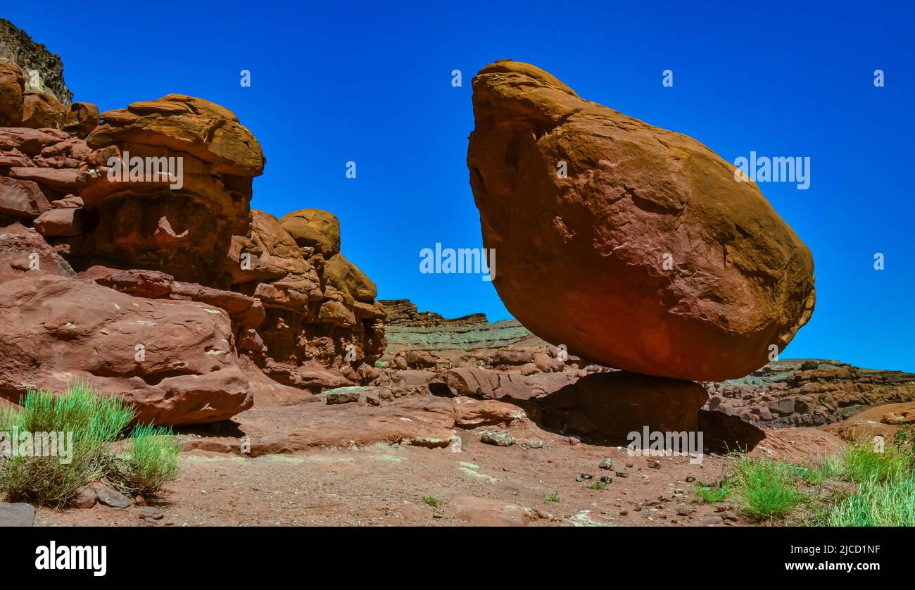 Balancing rock at the bottom of a canyon among Layered geological ...