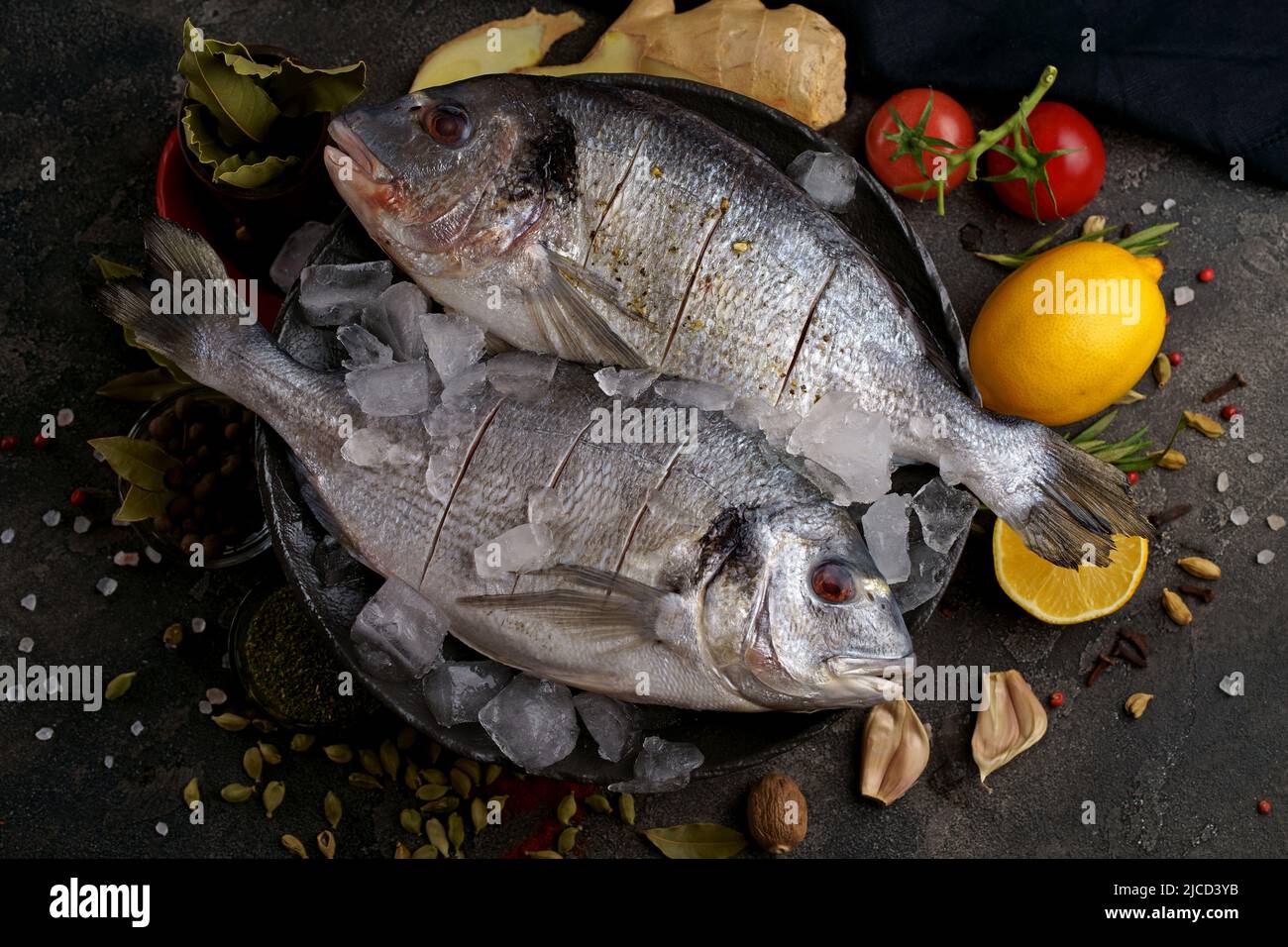 Fresh ready to cook raw bream fish dorado with ingredients and ...