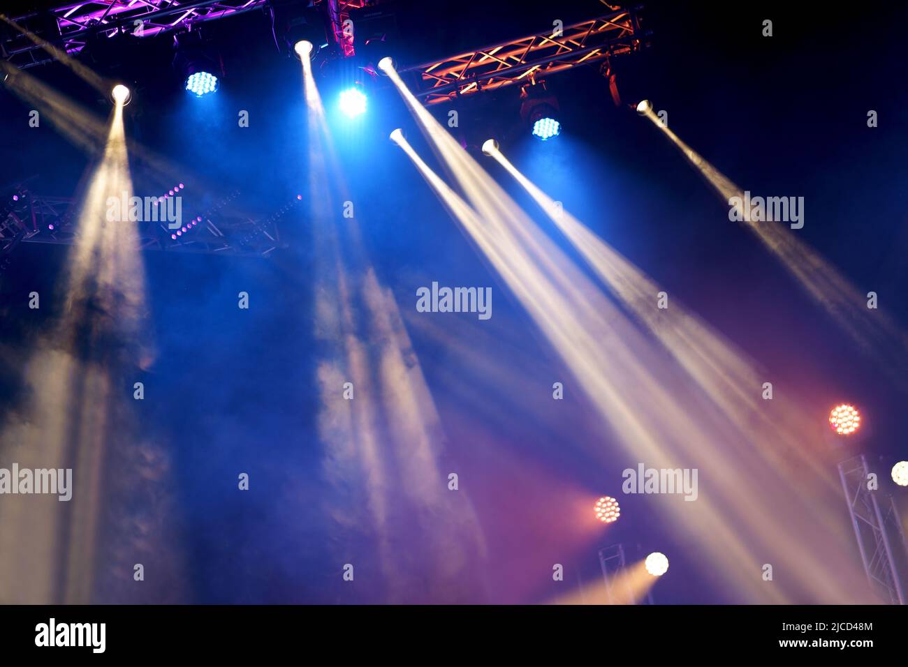Crowd at concert - Cheering crowd in bright colorful stage lights Stock ...