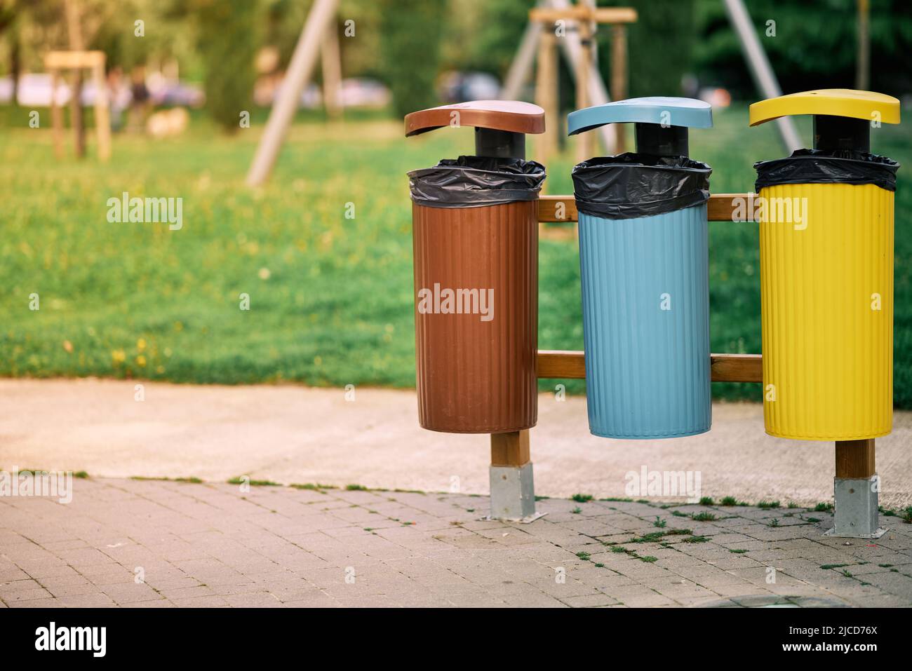Three bins with different colors to promote the recycling of garbage ...