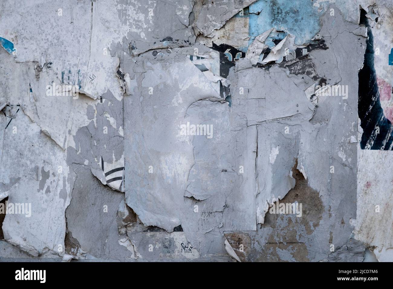 Old bulletin board on rustic wooden wall with rests of old torn posters ...
