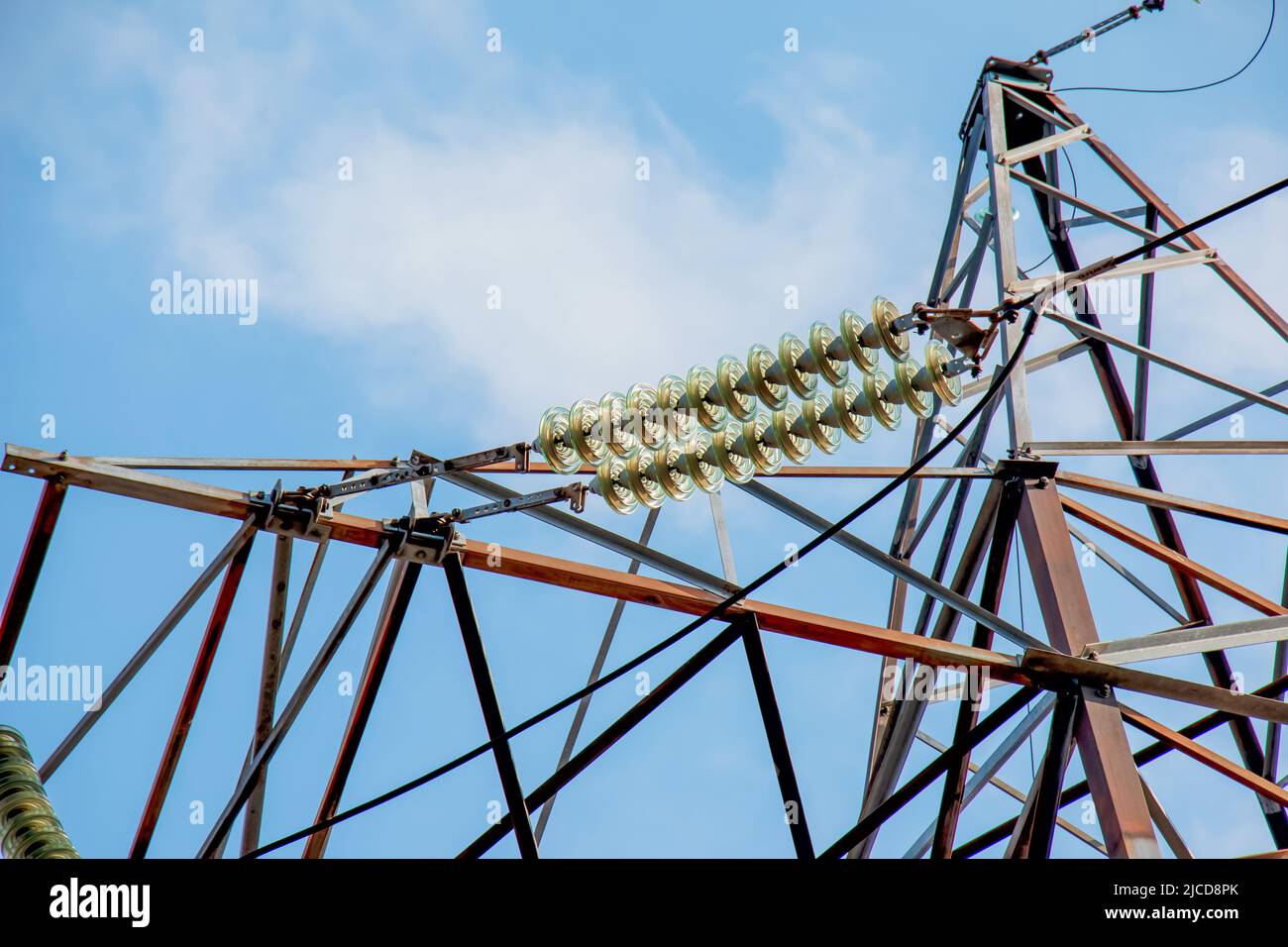 Close-up view of an electric tower with a beautiful blue sky background ...