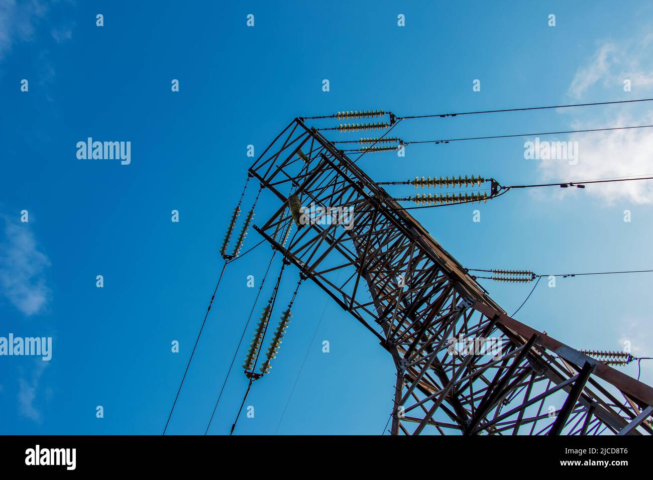 Close-up view of an electric tower with a beautiful blue sky background ...