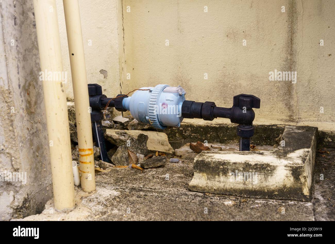 The water meter on the cement platform is cracked Stock Photo - Alamy