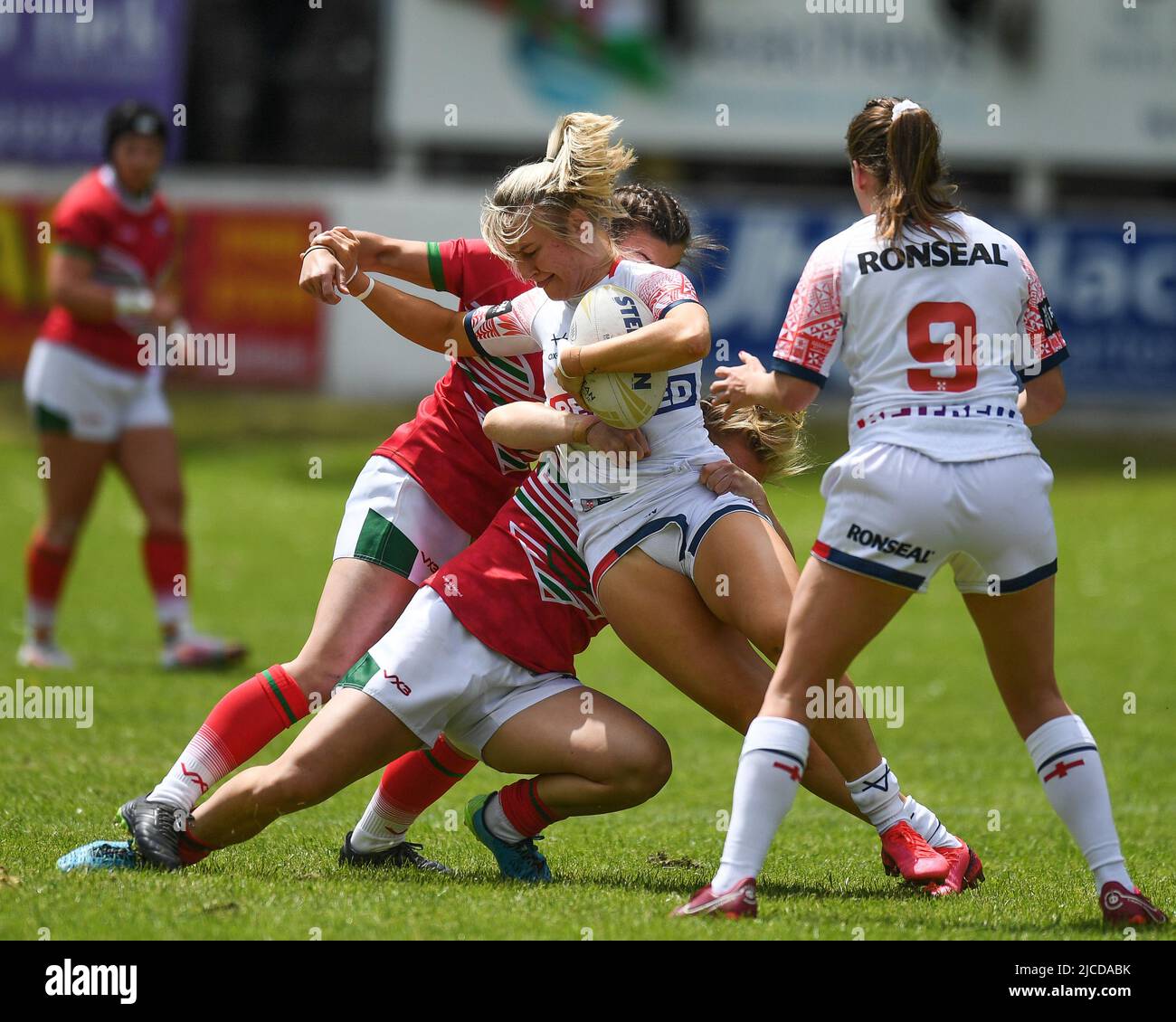 Tara Stanley of England RL, try to break through the Welsh defence ...