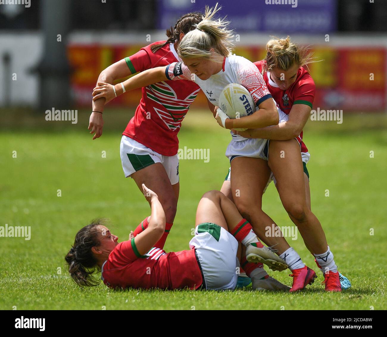Tara Stanley of England RL, try to break through the Welsh defence ...