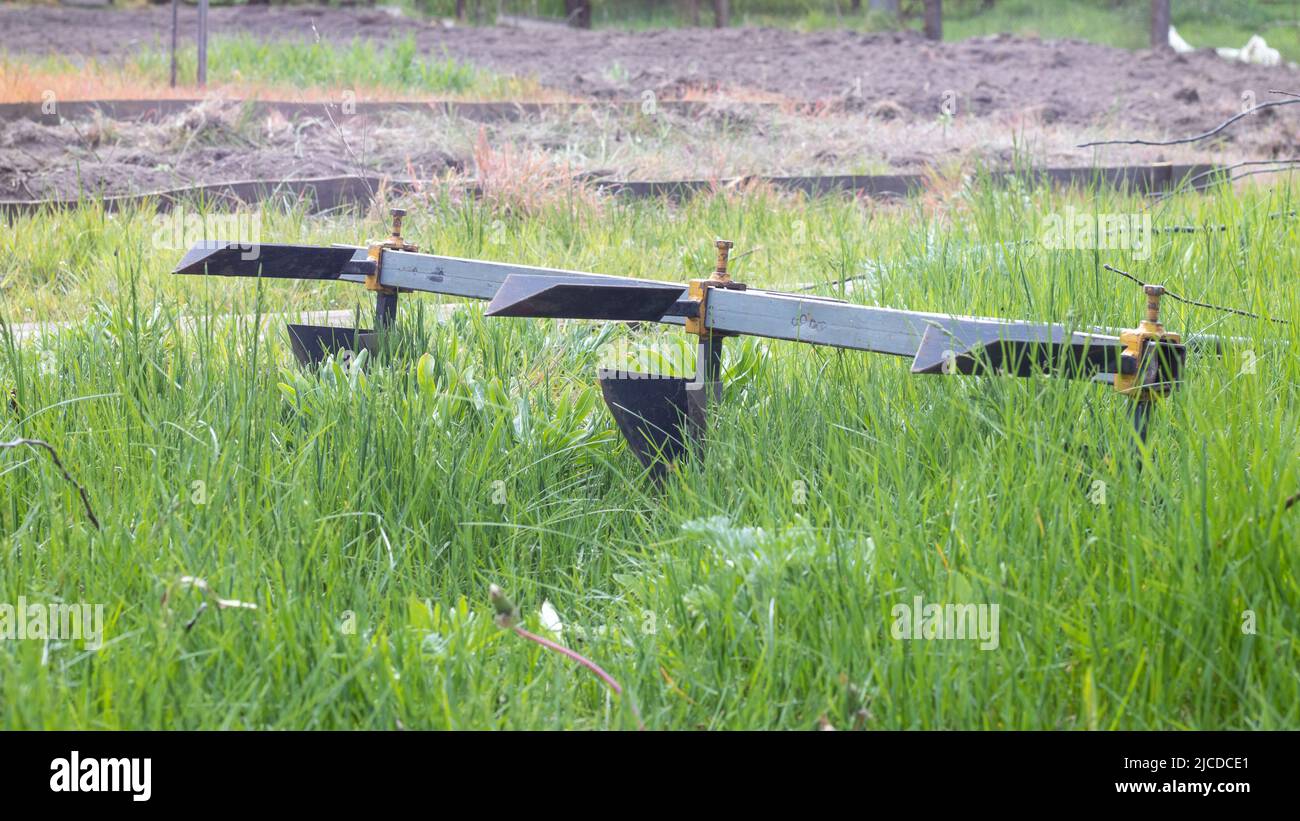 Agricultural manual metal plow on the field. Plowing the land before ...